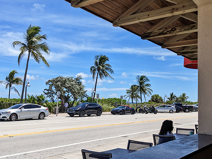 The view from Boston's patio&mdash;palm trees swaying as cars cruise along A1A. The beach is so close you can practically taste the salt air.