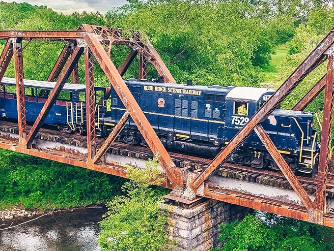 The iron bridge carries more than just a train—it transports passengers between centuries while the Toccoa River flows eternally below.