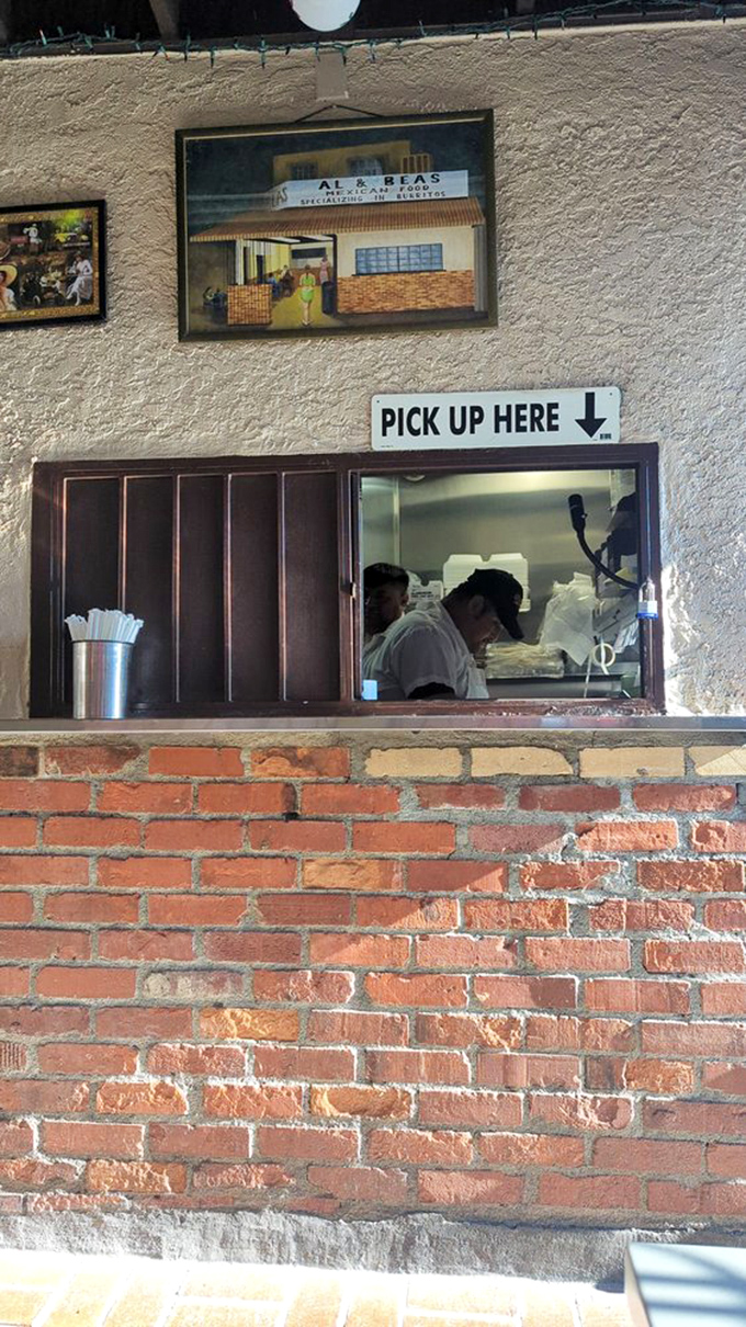 The pickup window: where hopes and dreams are exchanged for foil-wrapped packages of happiness. Note the vintage photo above.