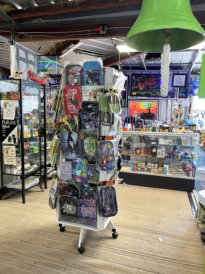 A spinning rack of colorful trinkets under the watchful eye of a green bell. Impulse purchases have never looked so temptingly organized.