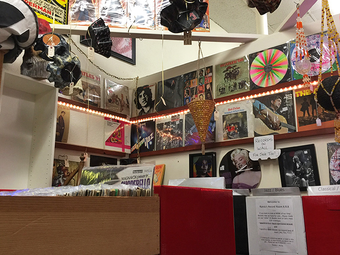 Album covers create a mosaic of musical history, with legends like Marilyn Monroe and Jim Morrison watching over vinyl treasures waiting to spin again.