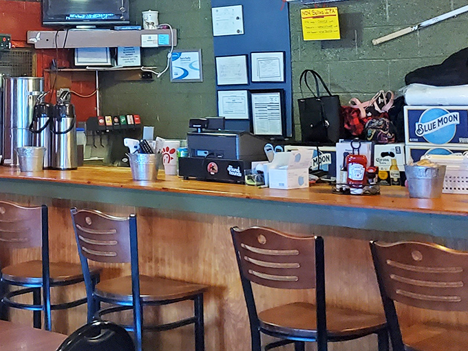Where the magic happens. The humble register area, adorned with local memorabilia, is command central for this beloved steakhouse operation.