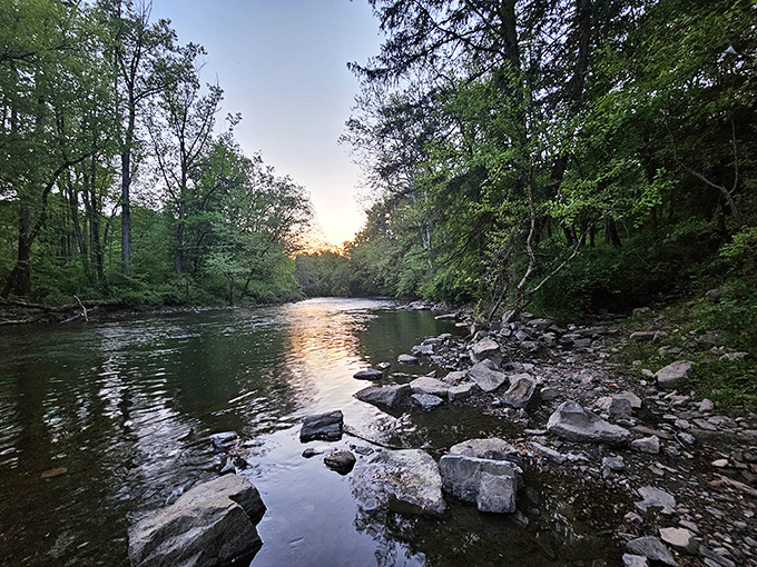 Swatara Creek's gentle current reflects sunset hues while rocks stand sentinel&mdash;nature's version of front-row seating to the greatest show on earth.