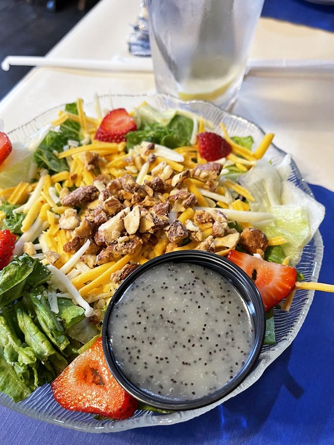 A salad that doesn't apologize for being healthy, brightened with strawberries and nuts that make eating greens feel like a reward, not a punishment.