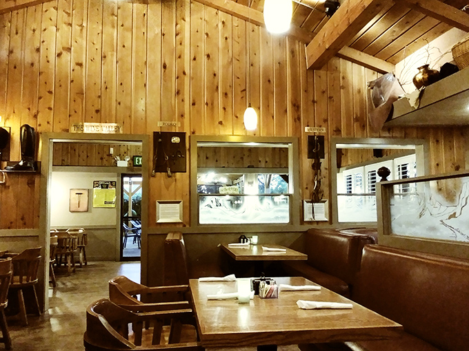 Dining room warmth that makes you want to linger. Pine-paneled walls and thoughtful lighting create the backdrop for memorable meals.