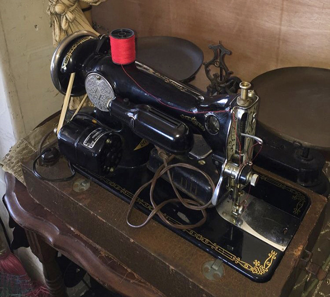 A vintage Singer sewing machine, complete with ornate detailing, recalls an era when "fast fashion" meant your grandmother working through the night.