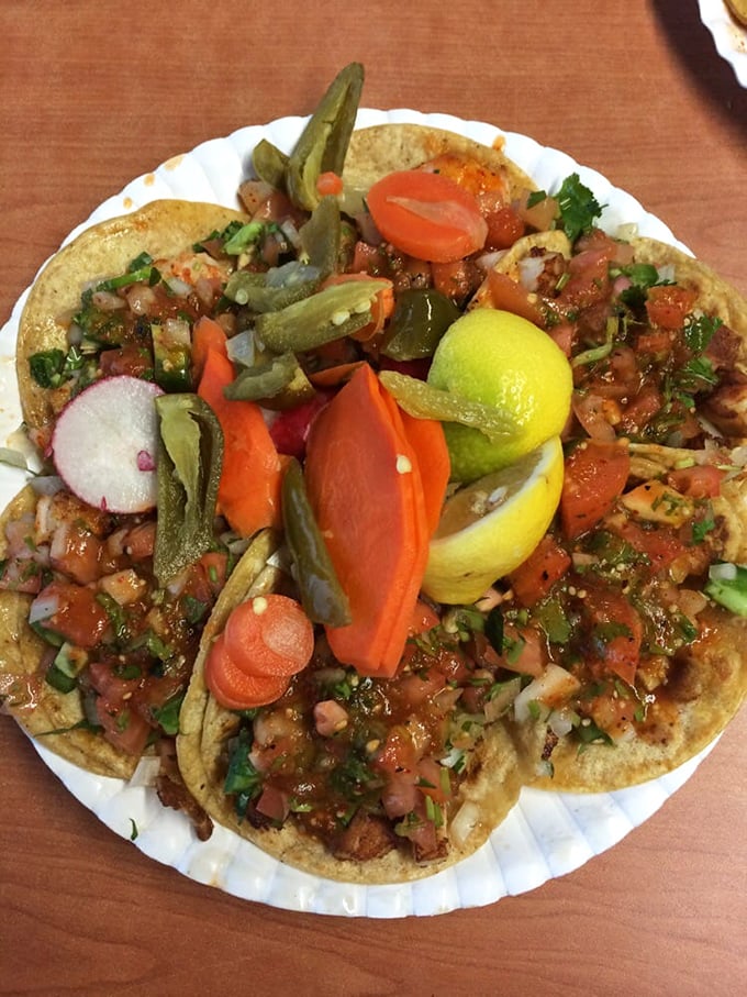 Tacos dressed for success with all the fixings. That lime wedge isn't just garnish—it's the conductor of this flavor orchestra.