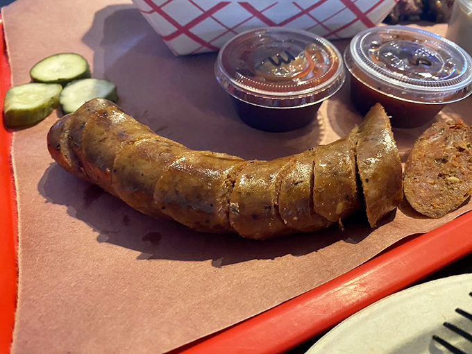 Smoked sausage that snaps when you bite it, releasing a juicy flavor explosion. Simple pickles on the side provide the perfect acidic counterpoint.