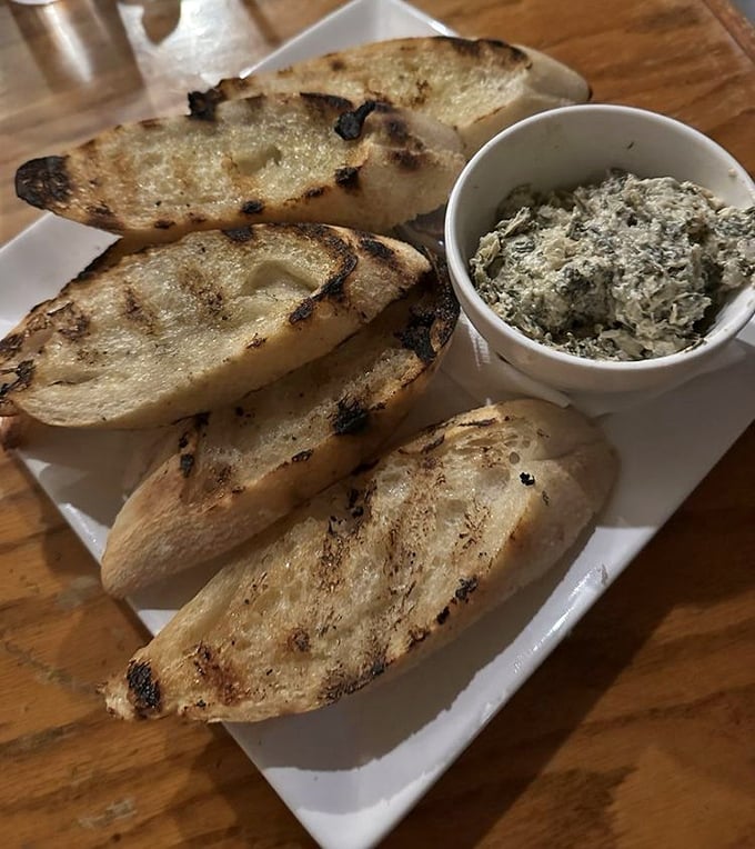 Grilled bread soldiers lined up for their heroic mission: delivering the perfect amount of creamy dip from plate to mouth without casualties.