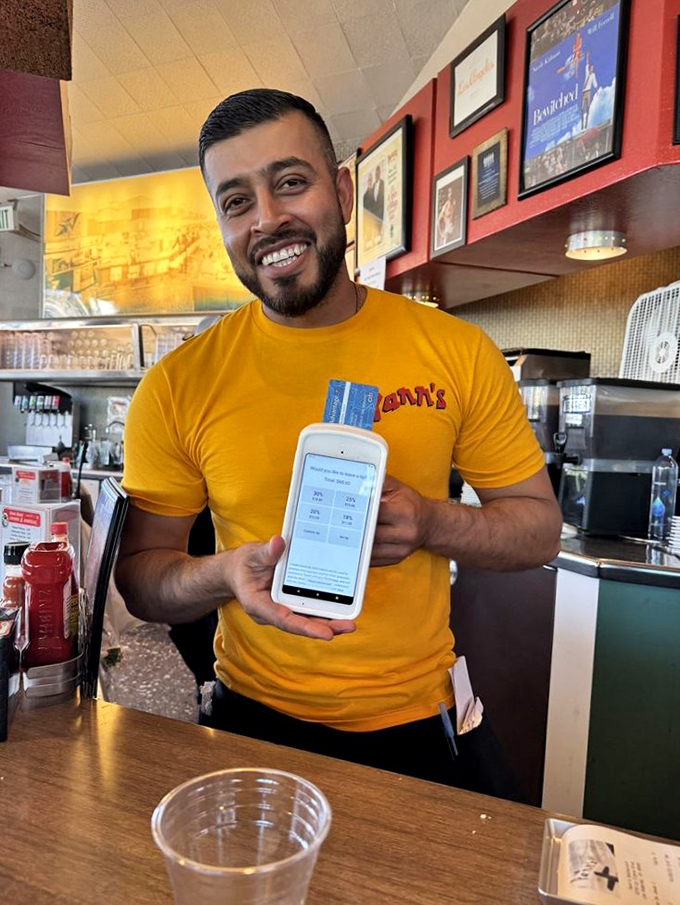 The smile says it all&mdash;genuine hospitality never goes out of style. This is service with actual joy, not the corporate-mandated kind.