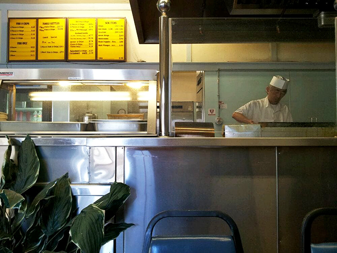 Where the magic happens: skilled hands working with practiced precision. Some artists use paint; these artists use batter.