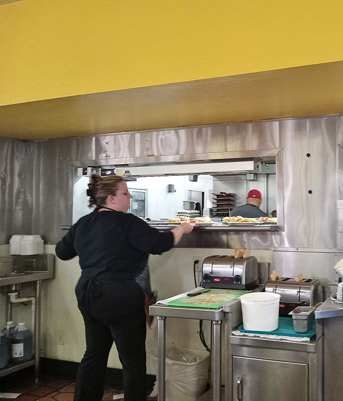 Where breakfast magic happens&mdash;skilled hands orchestrating the morning symphony of eggs, toast, and perfectly timed plate delivery.