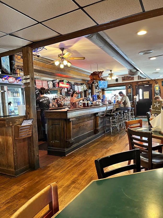 The bar area serves as command central, where barbecue dreams are fulfilled and cold beverages flow to extinguish the pleasant burn of spice-rubbed meats.