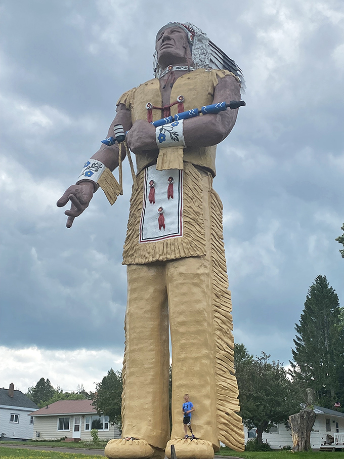 Talk about a size comparison! This youngster could comfortably use Hiawatha's moccasin as a studio apartment with room for guests.