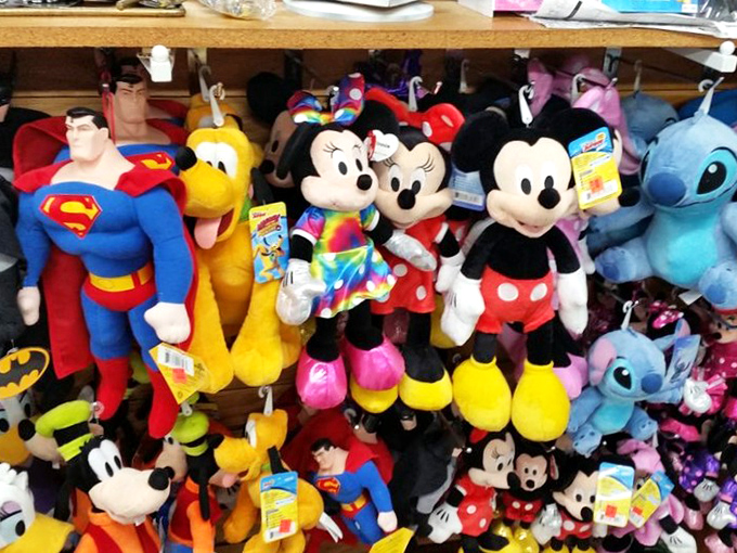 A superhero lineup of plush companions. Superman, Mickey, and friends waiting to be adopted into homes where they'll fight dust bunnies instead of villains.