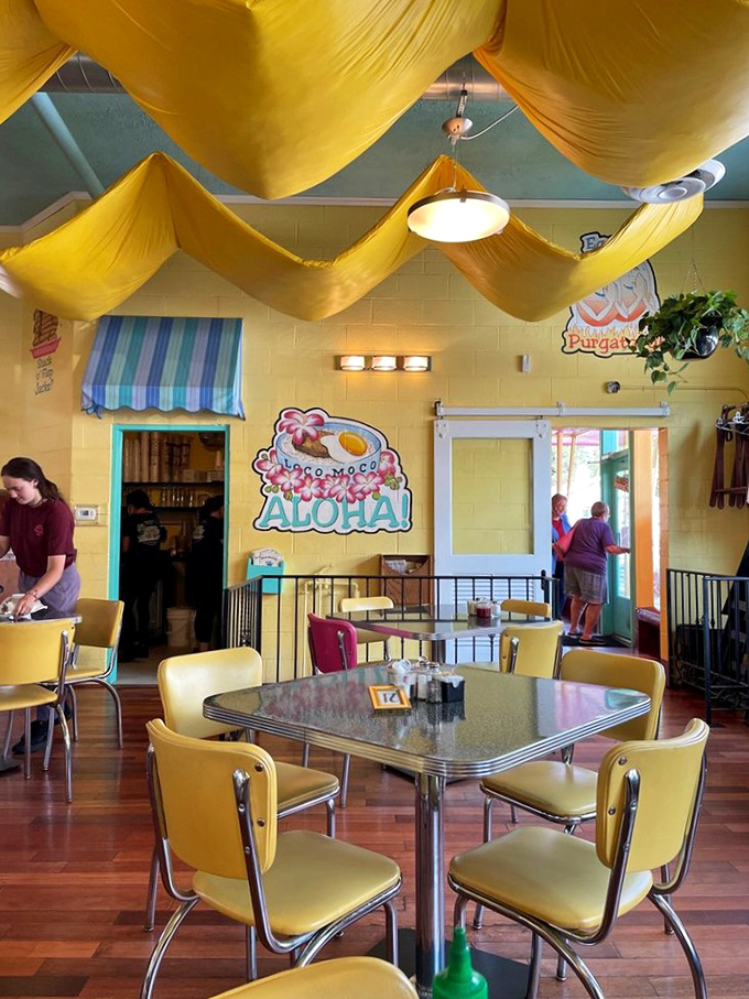 Yellow chairs, yellow drapes, and "Aloha" signs&mdash;this isn't just a dining room, it's a vacation for your breakfast routine. 