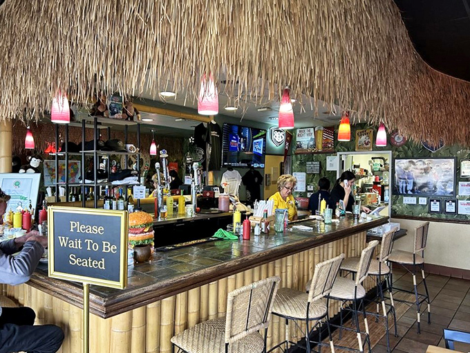 The tiki bar isn't just decoration &ndash; it's the command center where burger magic happens beneath strings of colorful lights.