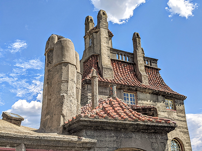 The castle's roofline resembles what happens when a medieval architect discovers concrete and decides to get experimental with chimneys and turrets.