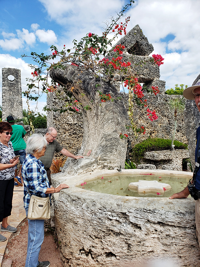 Visitors marvel at the precision of Ed's water features, touching the smooth coral surfaces polished by a man determined to impress his lost love.