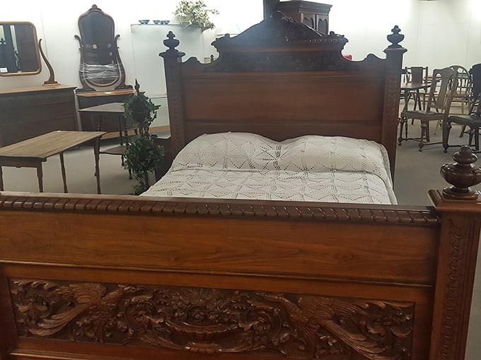 Hand-carved Victorian bed frame that whispers stories of generations who dreamed beneath its ornate wooden embrace.