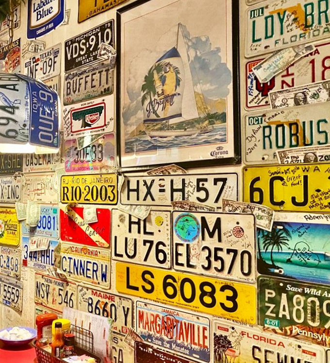 A mosaic of memories: Every license plate on these walls represents someone who came hungry and left with a story. 