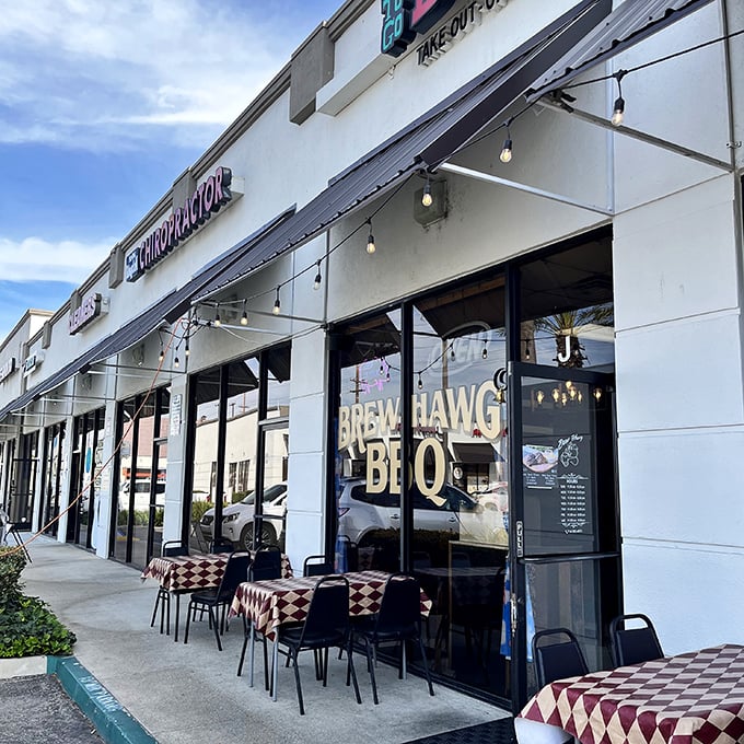 Red-checkered tables outside this strip mall BBQ joint hint at the down-home flavors waiting inside.