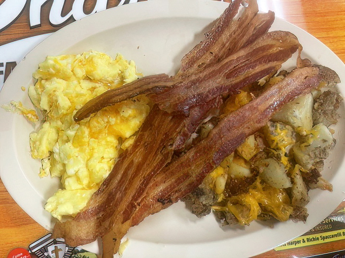 Two eggs any style accompanied by crispy bacon, proving that breakfast perfection doesn't require complicated molecular gastronomy.