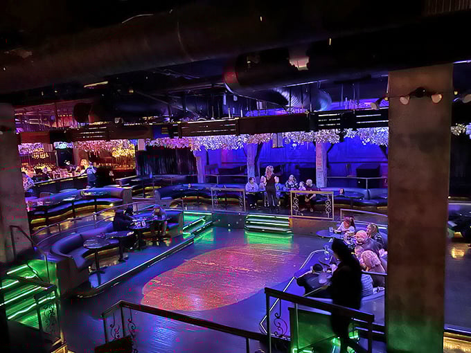 A multi-level dining experience bathed in purple and green light. The perfect stage for both your dinner and the theatrical performances that accompany it.