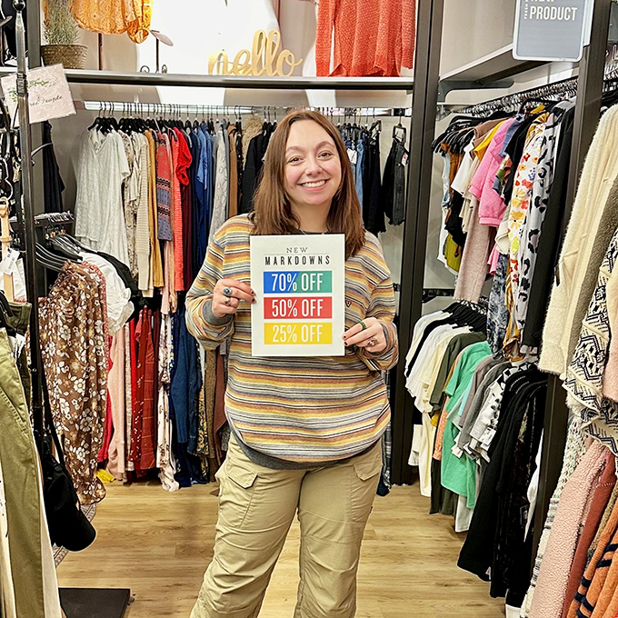 Nothing brings a smile quite like seeing "70% OFF" held by someone clearly thrilled about their fashion-forward financial decision.