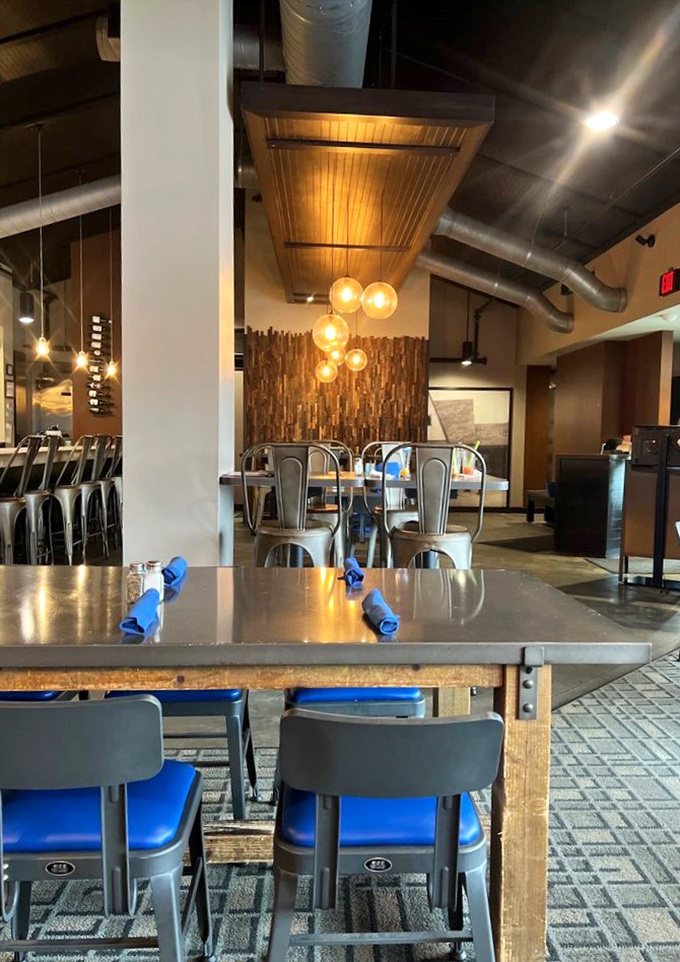 Modern industrial elements meet warm wood tones in a dining space that feels both contemporary and timeless &ndash; like the menu itself.