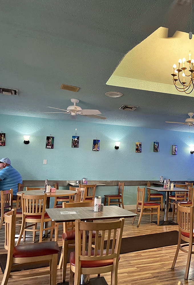 Mint walls and wooden tables create a no-nonsense dining space where the food, not the decor, rightfully takes center stage.