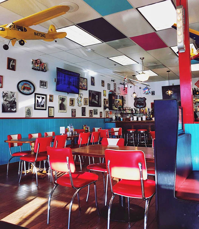 Sunlight streams through windows illuminating a diner straight from American mythology. Those red chairs aren't just seating &ndash; they're invitations to join the story. 