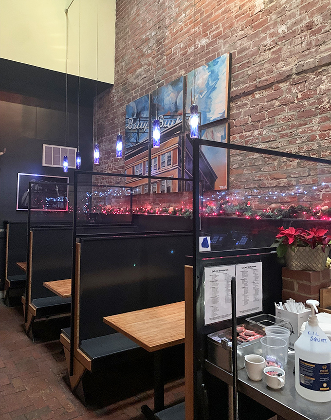 Blue pendant lights hang like jewels against exposed brick, creating dining nooks where conversations and coffee flow with equal enthusiasm.