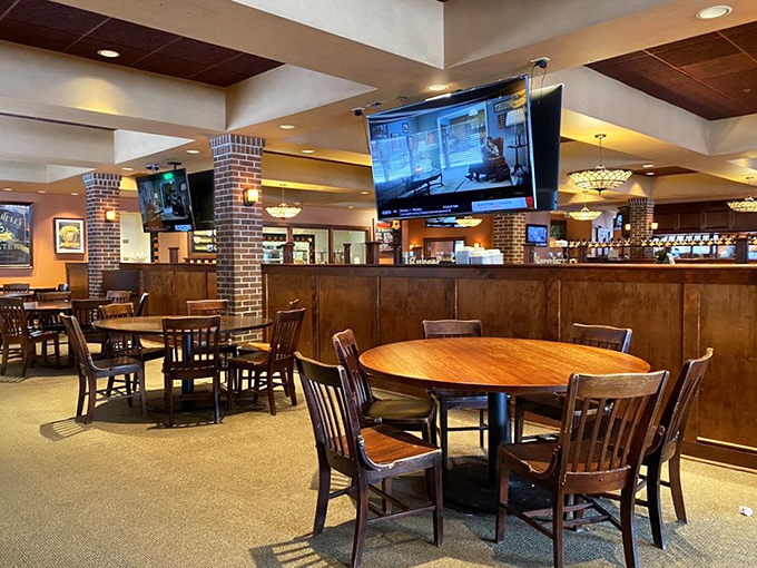 Comfortable seating, strategic TV placement, and warm lighting create the perfect atmosphere for both game day and date night.