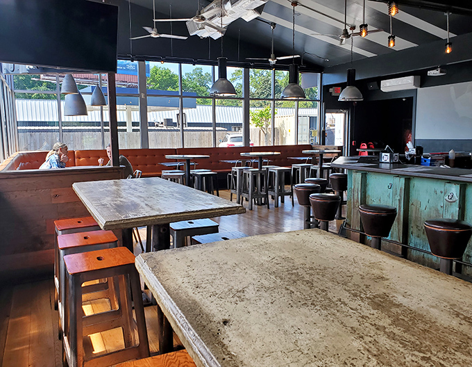 Concrete floors, wooden tables, and abundant natural light create a space that says, "We're serious about burgers, not about making you uncomfortable."