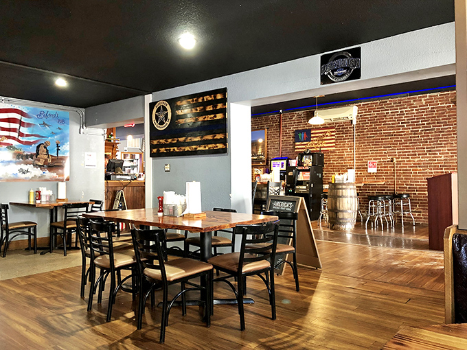 Wooden tables, brick walls, and patriotic touches create that quintessential heartland atmosphere where everyone feels like a regular.