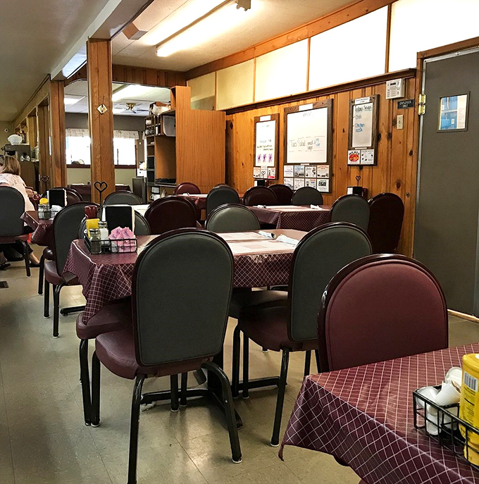 Simple tables set for serious eating business. In this dining room, conversations flow as freely as the coffee, creating the soundtrack of community.