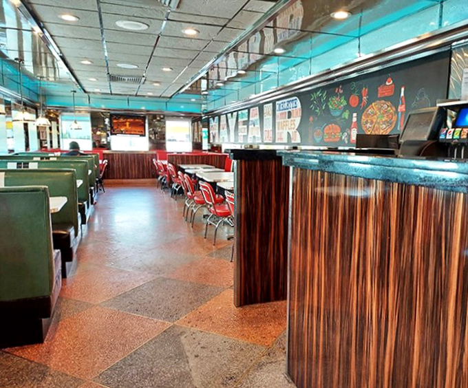 Green booths on one side, counter seating on the other. The classic diner layout that's been perfecting the art of comfort since forever.
