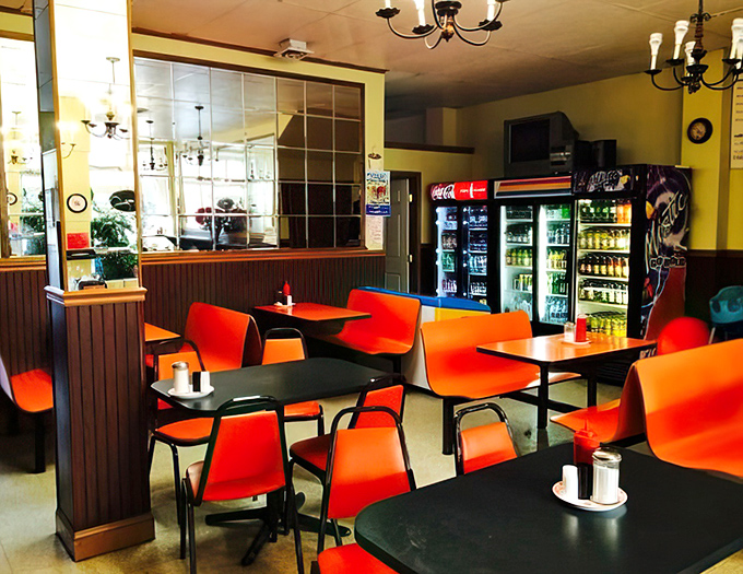 Classic diner aesthetics with those signature orange chairs&mdash;where comfort trumps style and nobody's complaining about it.