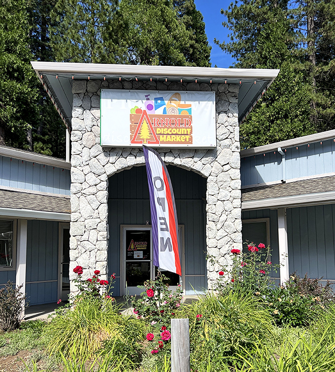 Arnold Discount Market's stone entrance and vibrant roses create the kind of curb appeal that makes you wonder if all grocery shopping should be this charming.