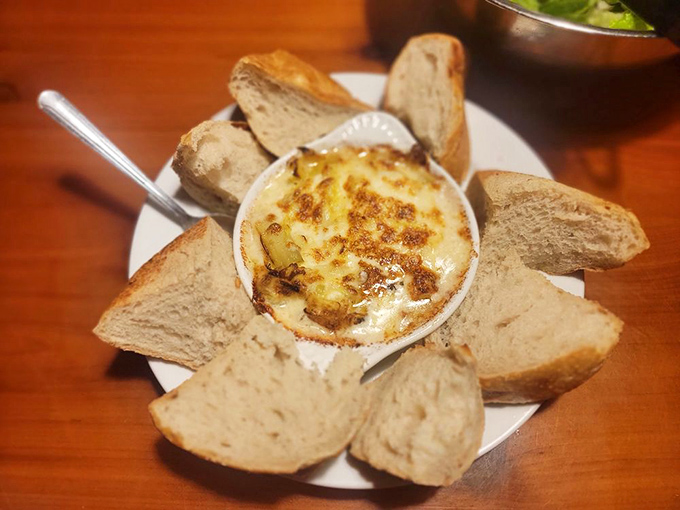 Bubbling artichoke dip surrounded by bread soldiers ready for dipping duty. It's the appetizer everyone fights over until the last scoop.