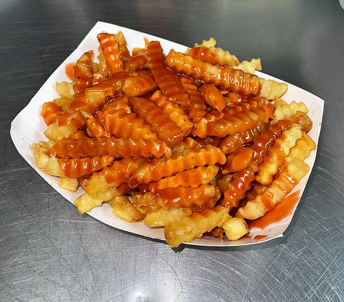 Crinkle-cut fries swimming in BBQ sauce &ndash; proving that even side dishes deserve their moment in the spotlight.