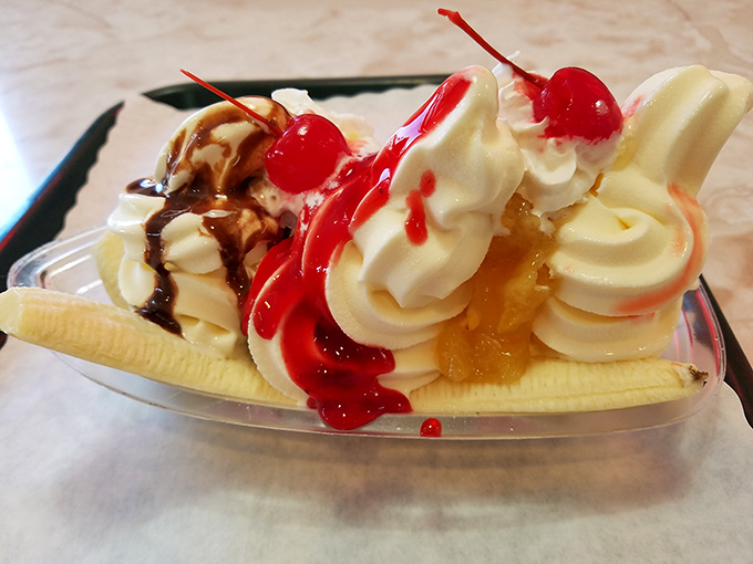 The banana split doesn't whisper; it announces itself with a carnival of whipped cream, cherries, and sauces that would make Willy Wonka blush.