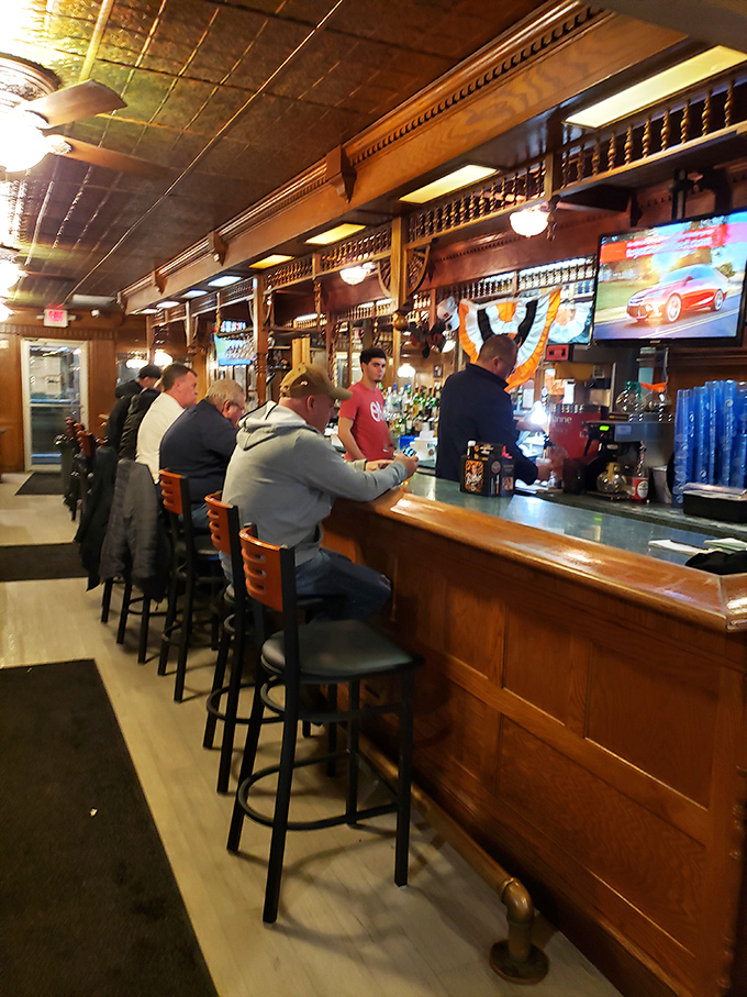 The bar serves as both social hub and strategic waiting area, where anticipation builds and the scent of smoking meat teases what's to come.