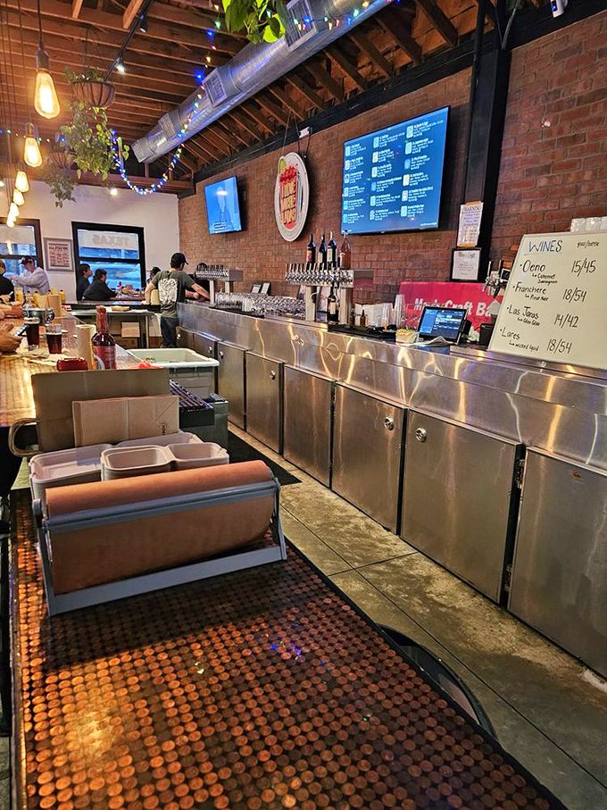 The bar area doubles as a front-row seat to barbecue theater, where craft beers and smoked meats form the perfect marriage of flavors.