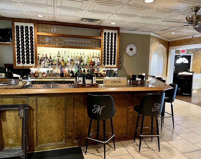 A bar that says "pull up a stool and tell me your troubles." The elegant "M" on the chairs reminds you whose house you're in.