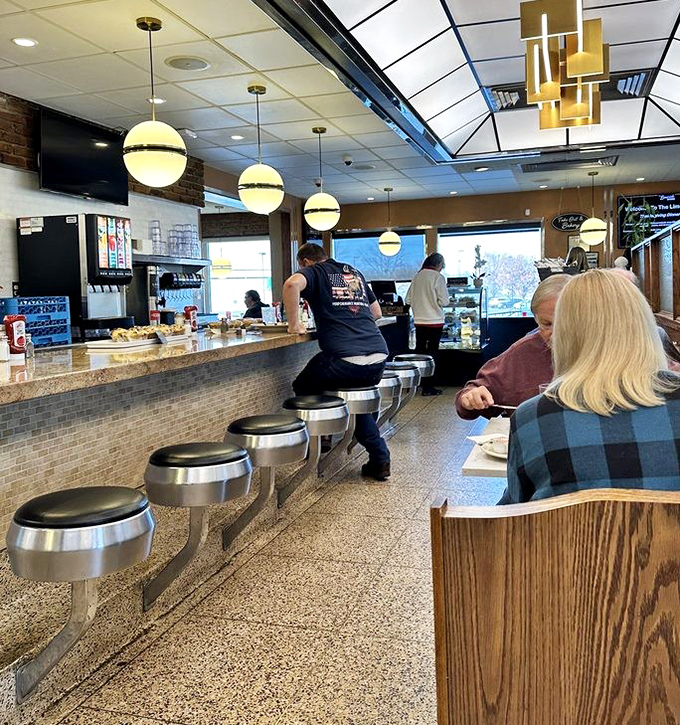 The counter where regulars become family. Those stools have supported the weight of countless stories, celebrations, and everyday moments.