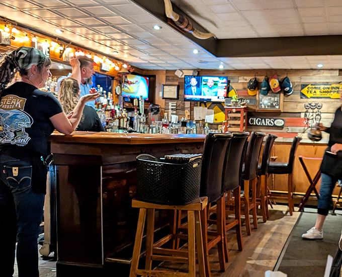 The bar seating offers front-row access to cocktail craftsmanship and the camaraderie that only comes from sharing stories with fellow meat enthusiasts.