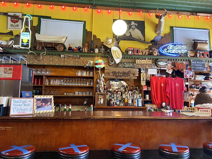 The bar stretches like a timeline of Texas drinking history &ndash; neon signs glowing with promises of cold beer and good times.