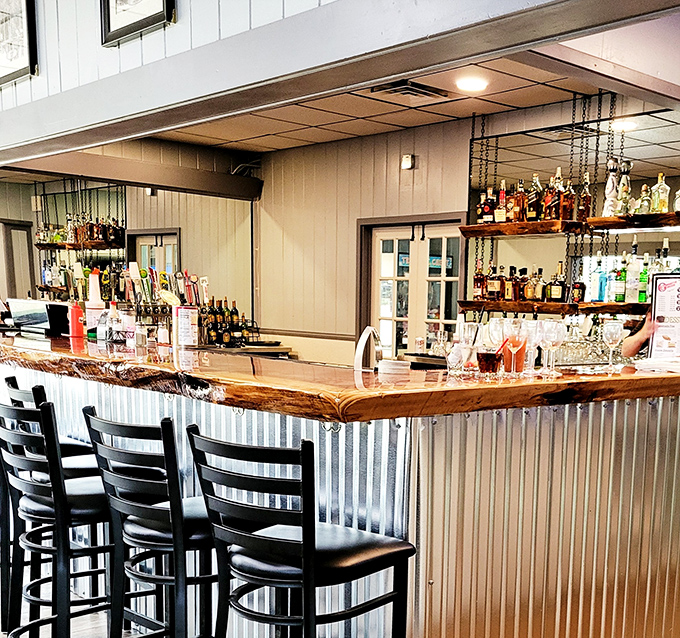 The bar area combines rustic charm with practical comfort, where locals gather to share stories as freely as they share appetizers.